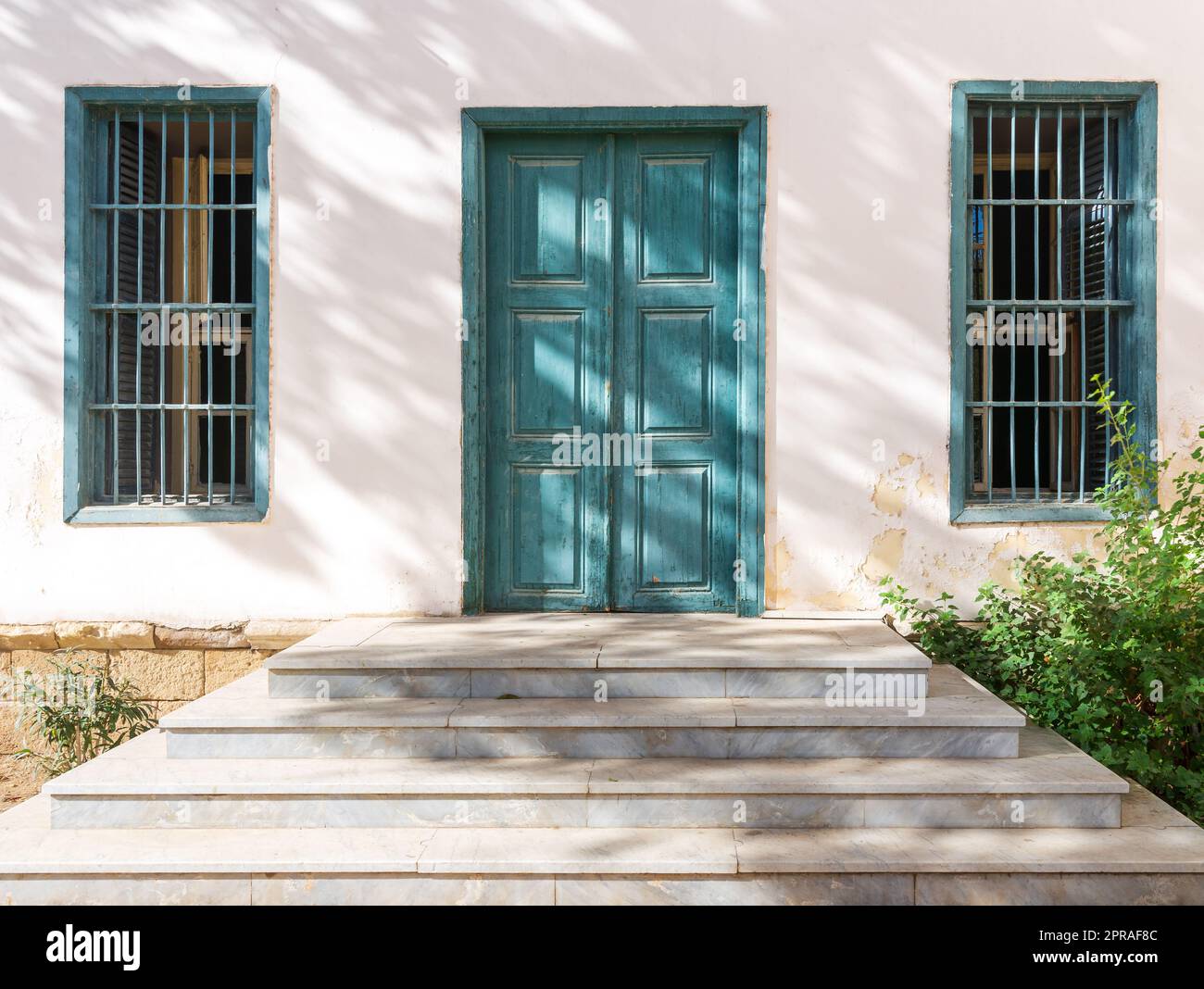 Marble stair in front of white wall with green wooden old grunge door ...