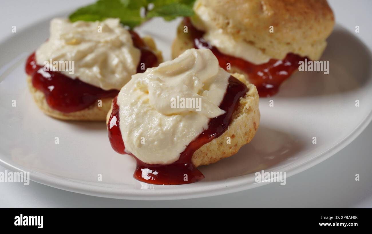 British scones with fruit jam and whipped cream Stock Photo - Alamy