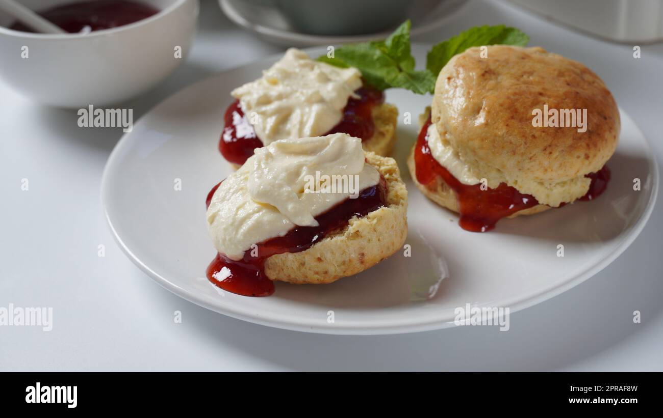 British scones with fruit jam and whipped cream Stock Photo - Alamy