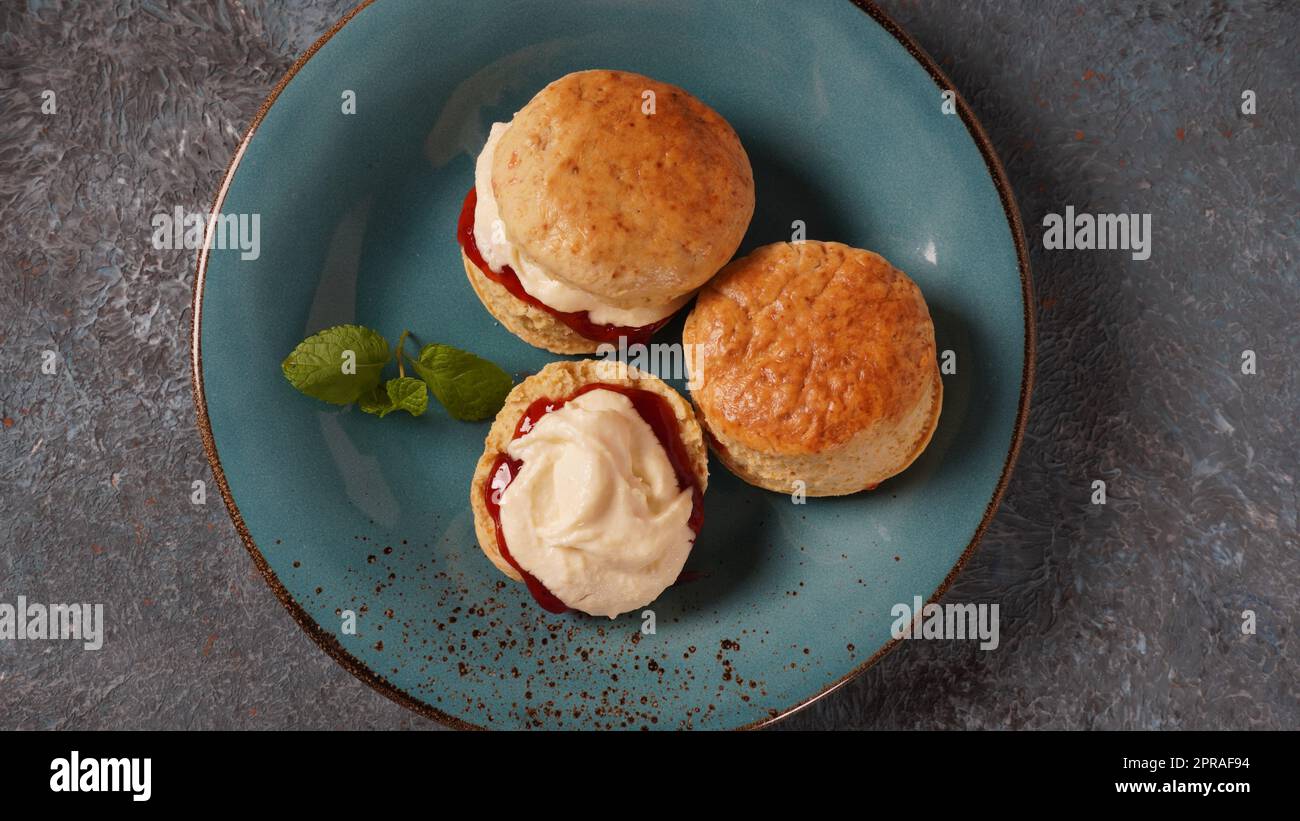 British scones with fruit jam and whipped cream Stock Photo - Alamy