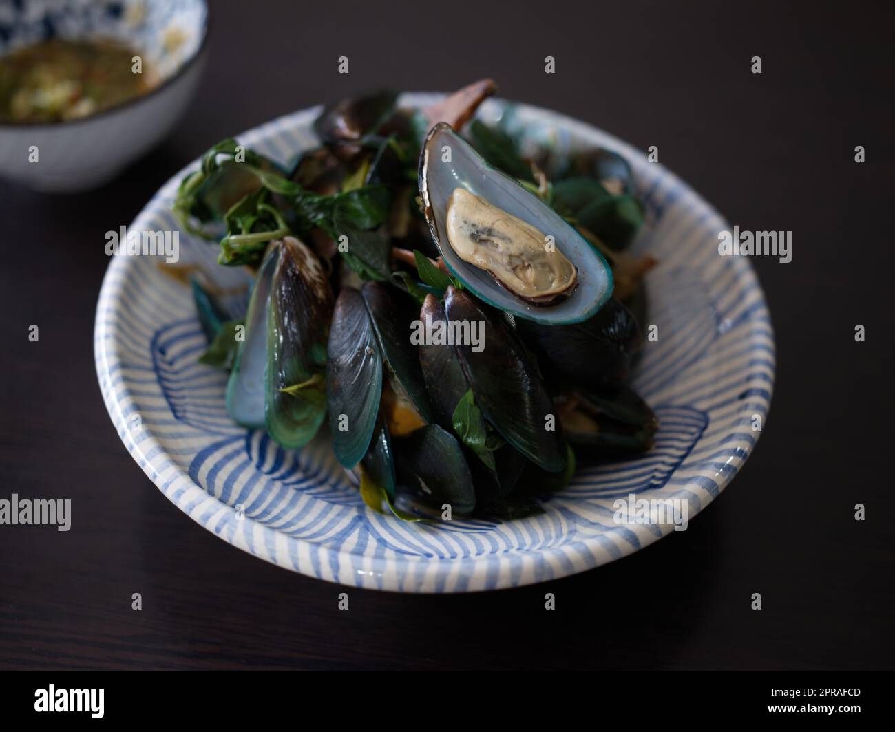 Thai Food steamed mussels with basil . Eaten with spicy sauce Stock ...