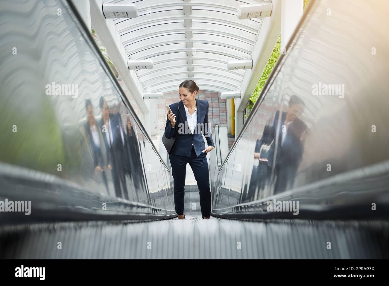 She always on call. a young businesswoman using a cellphone on an ...