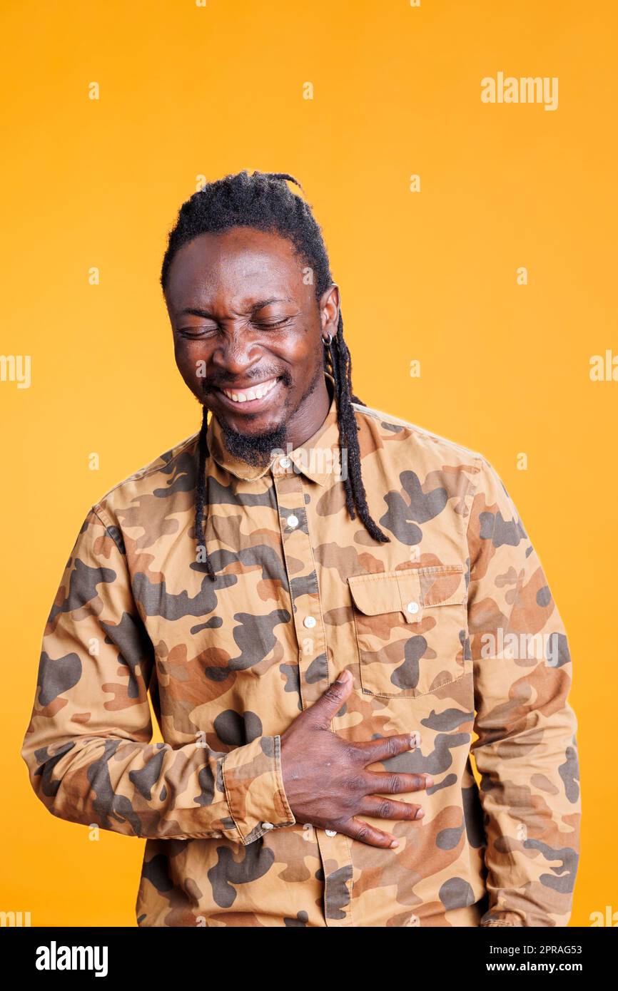 Portrait of smiling young adult laughting during studio shot, laughting ...