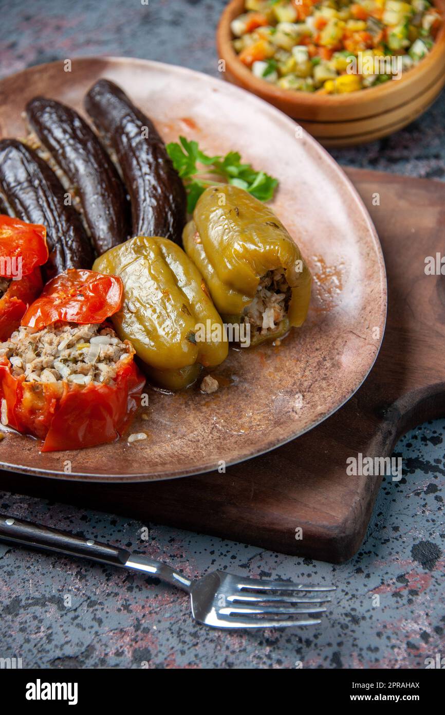 front view delicious vegetable dolma with salad on blue background ...