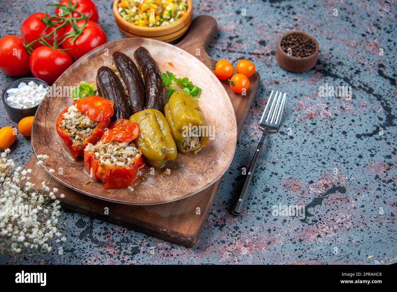 front view delicious vegetable dolma with salad and tomatoes on blue ...