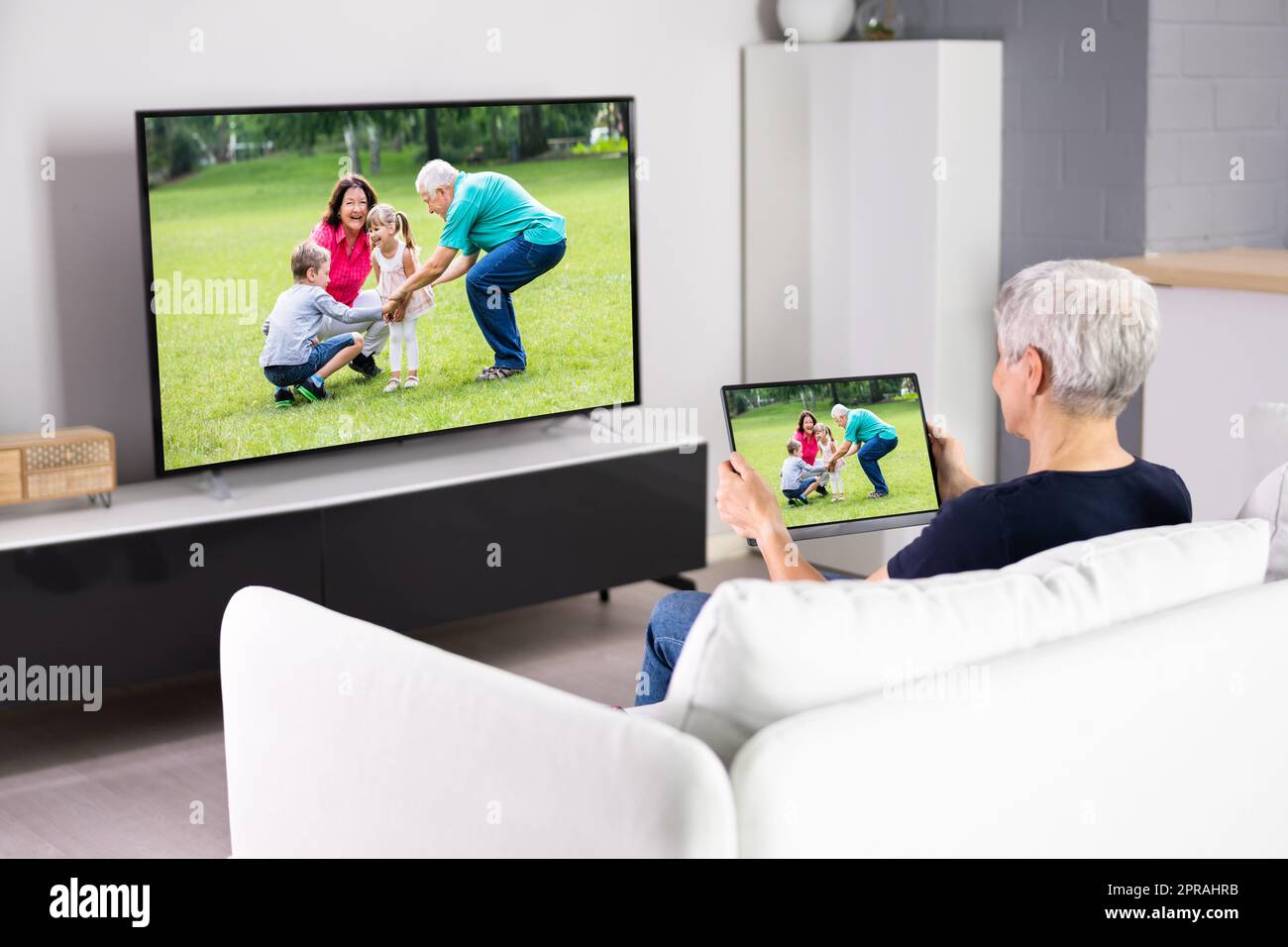 Woman Watching TV Through Tablet Television Stock Photo - Alamy