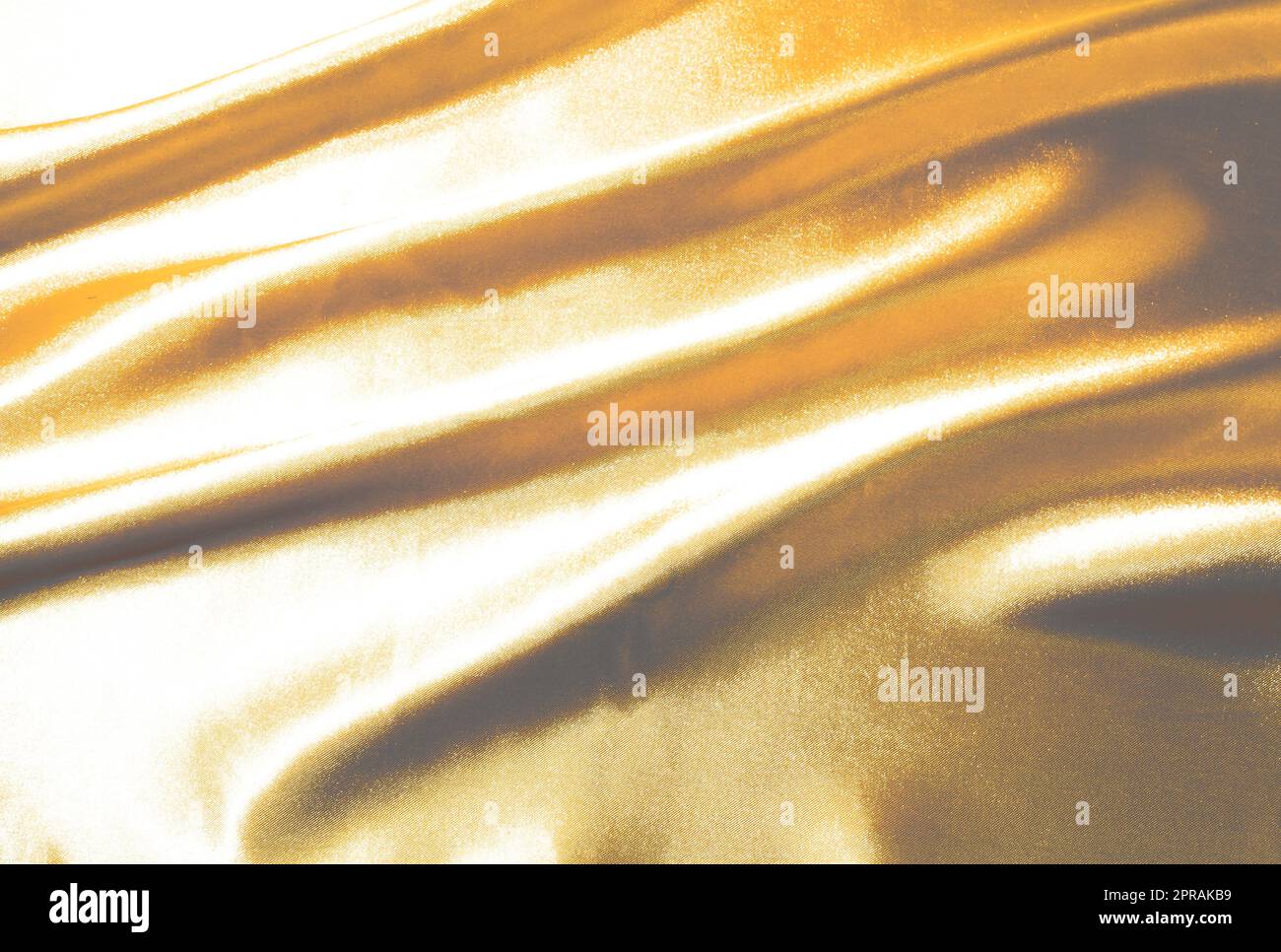 Smooth elegant golden silk or satin luxury cloth texture can use as ...