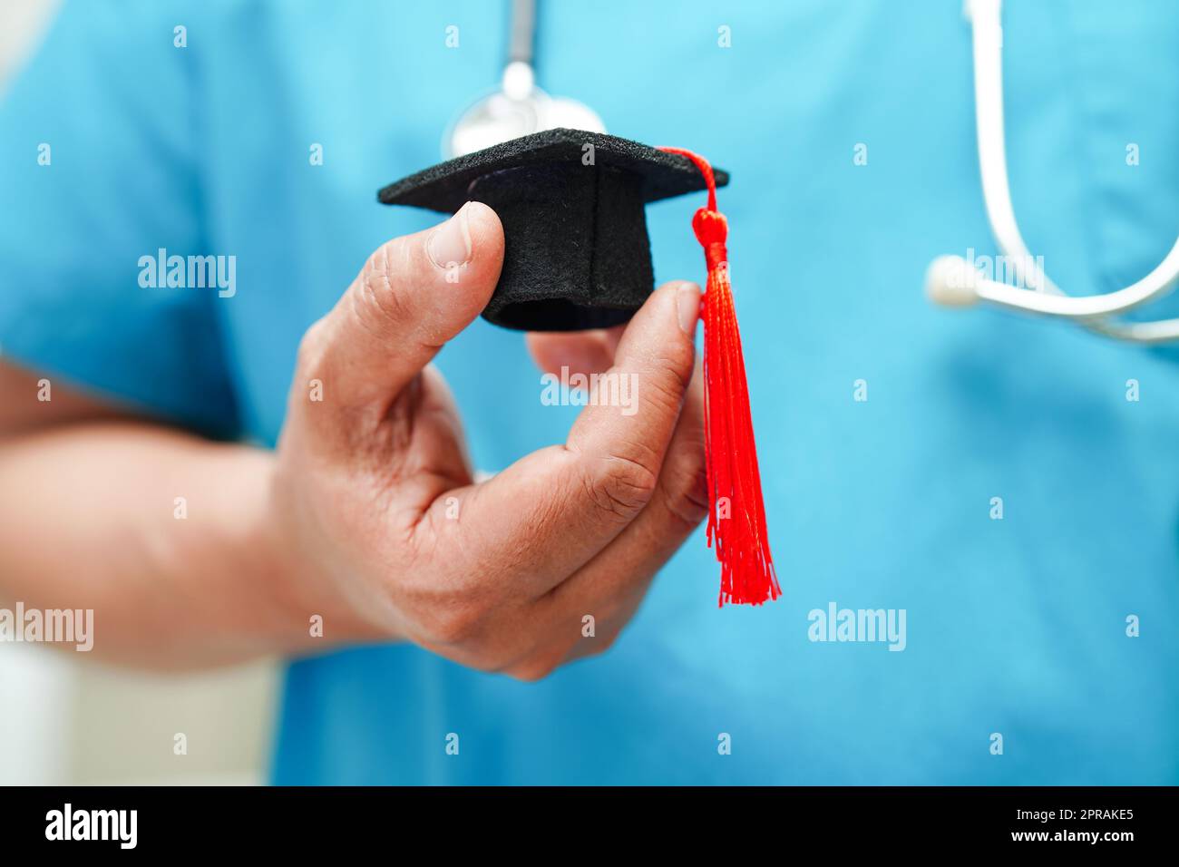 Asian woman doctor holding graduation hat in hospital, Medical ...