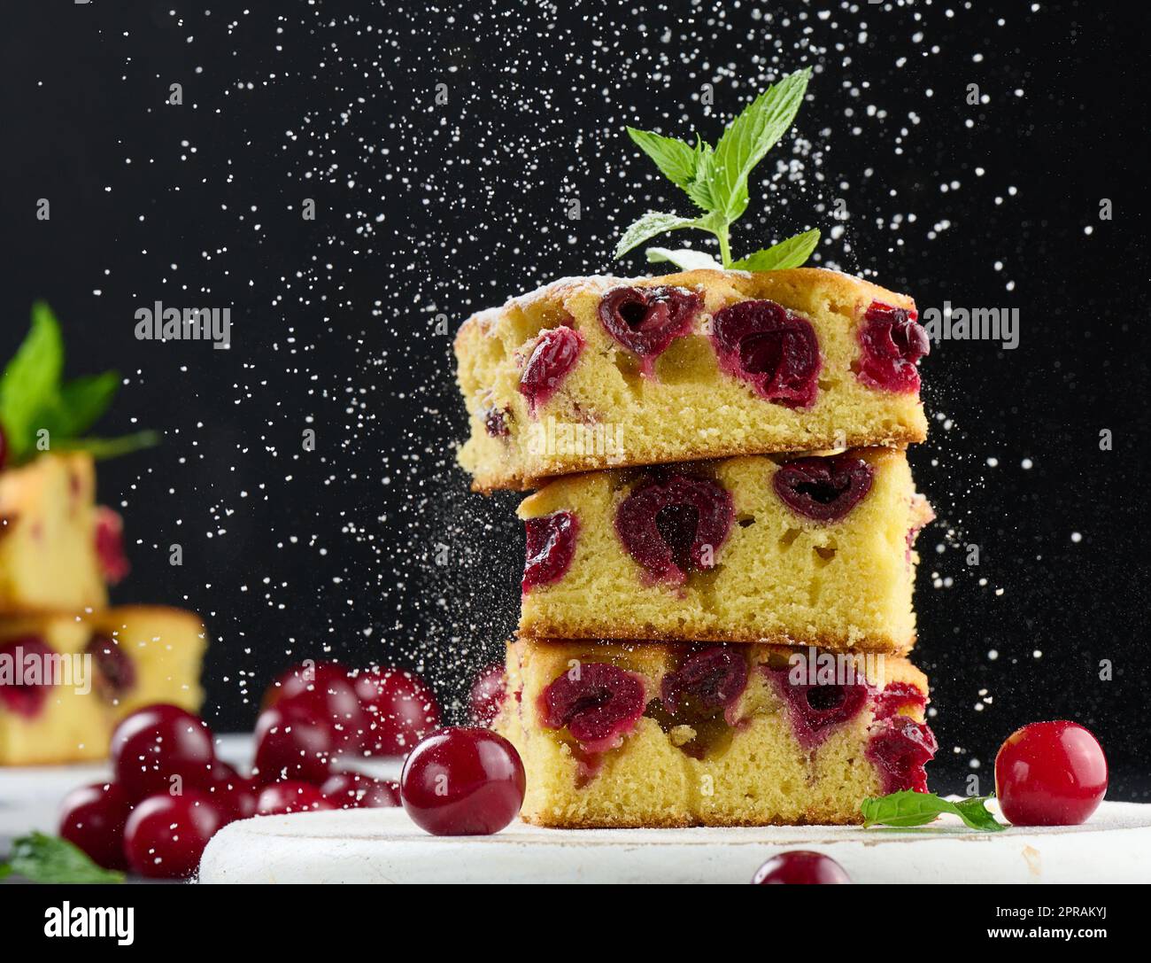 Baked sponge cake with cherries sprinkled with powdered sugar Stock ...