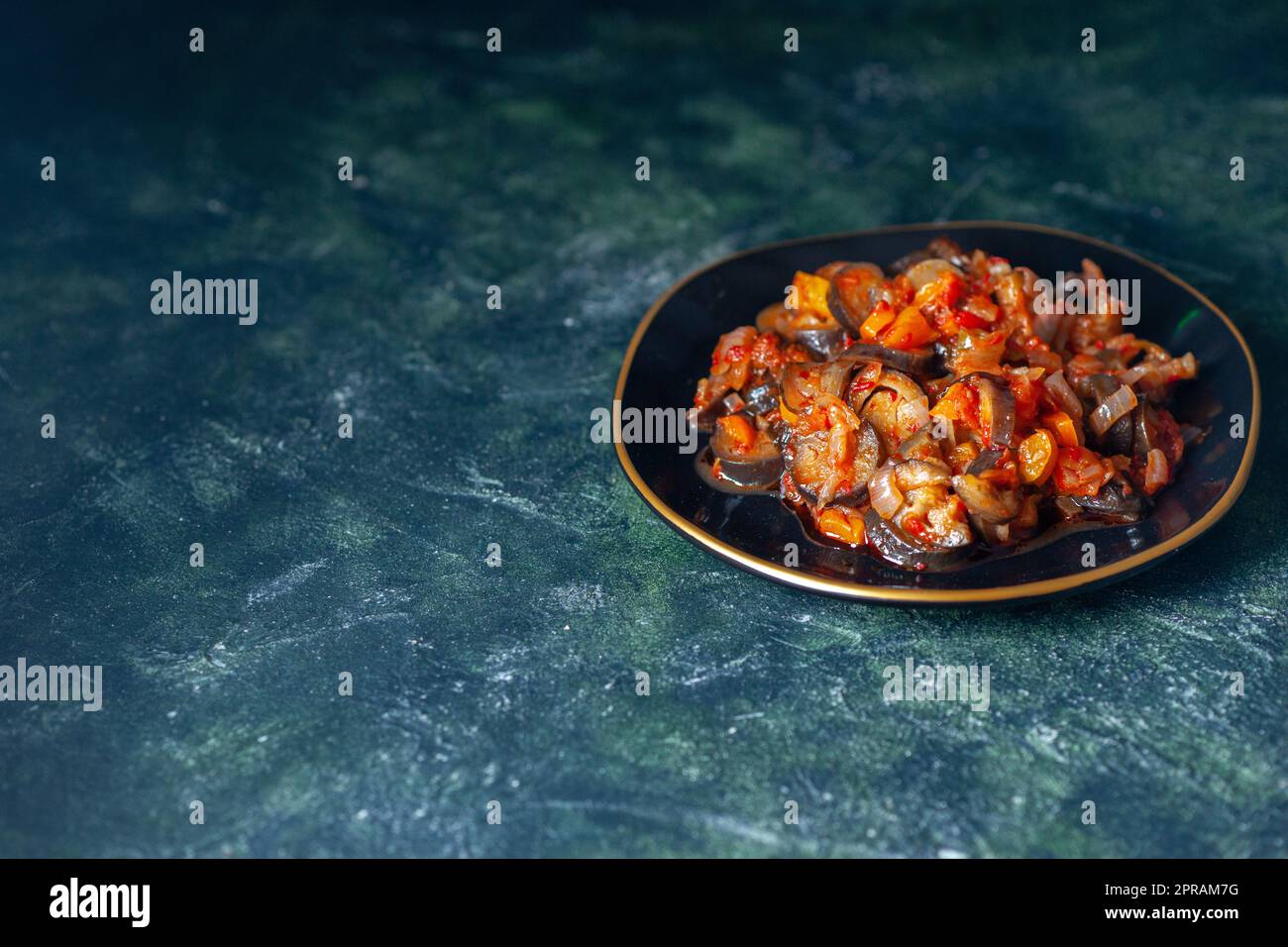 front view sliced cooked eggplants with extra dip inside plate on dark ...