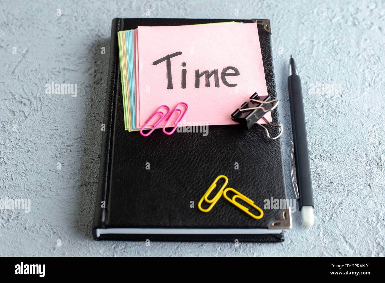 front view time written note with stickers notepad and pen on white ...