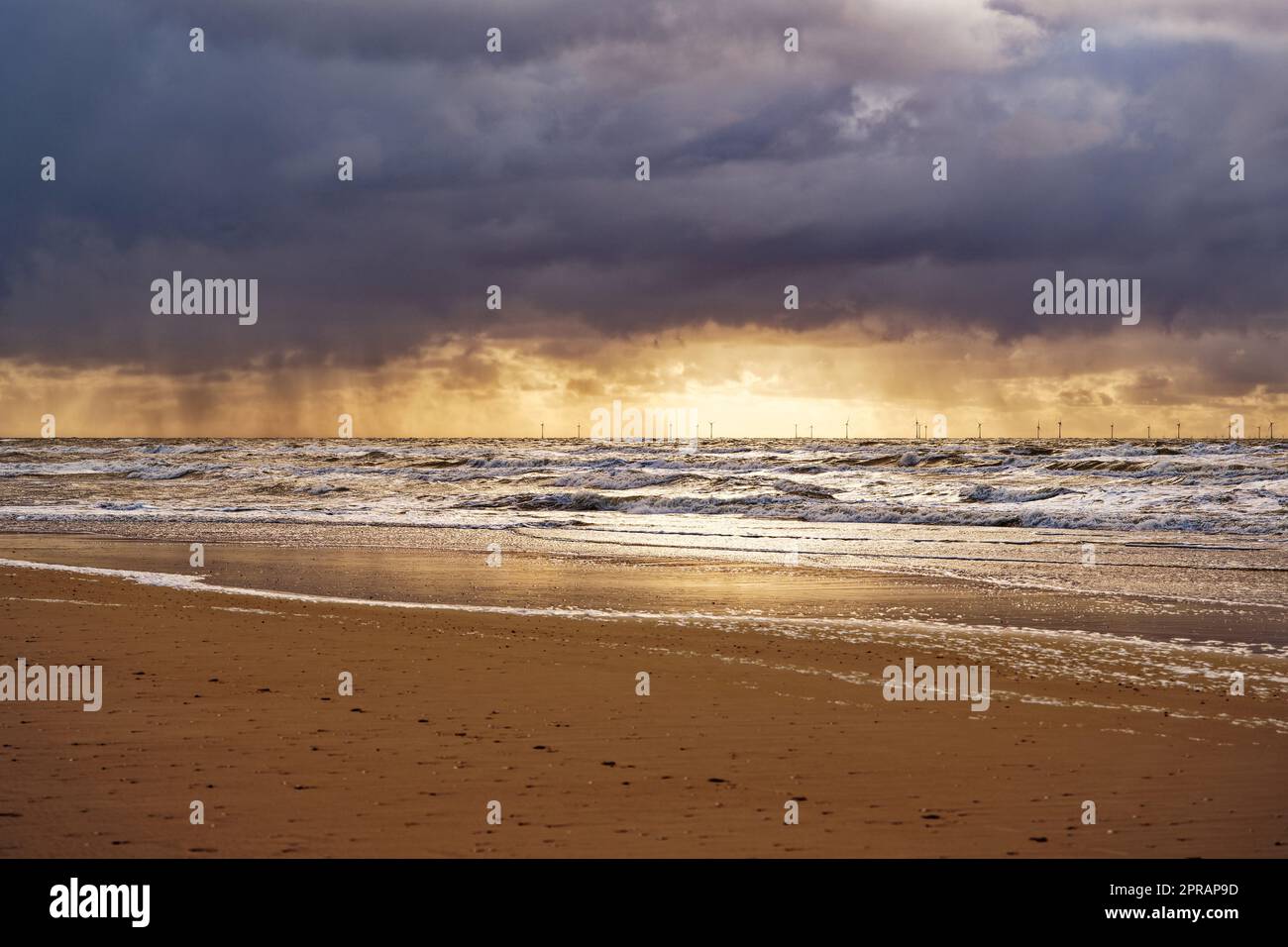 View to the ocean at sunset. Cloudy sky and illuminated horizon. North ...