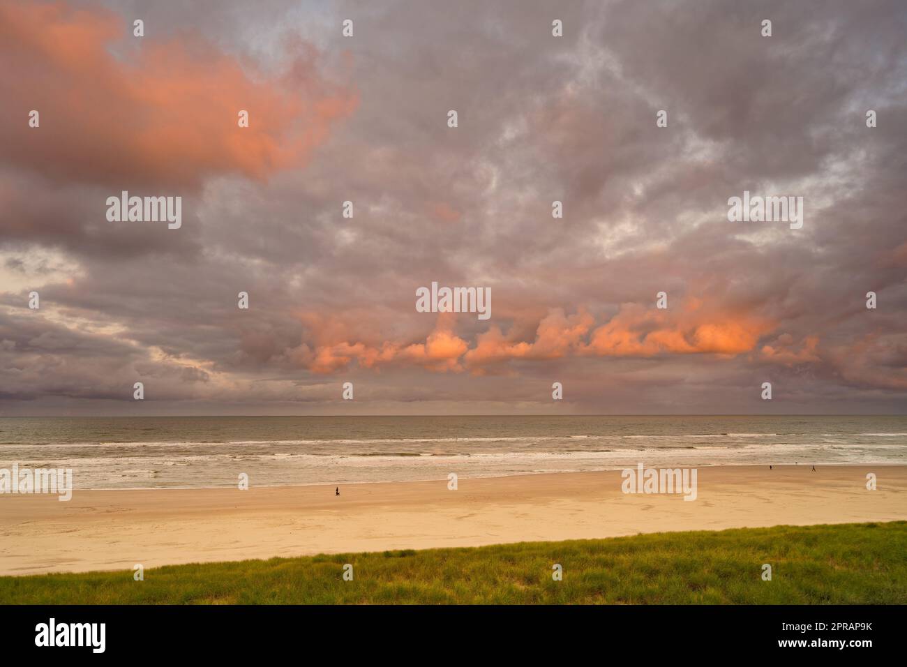 View to the ocean at sunrise. Some of the clouds are illuminated by the ...