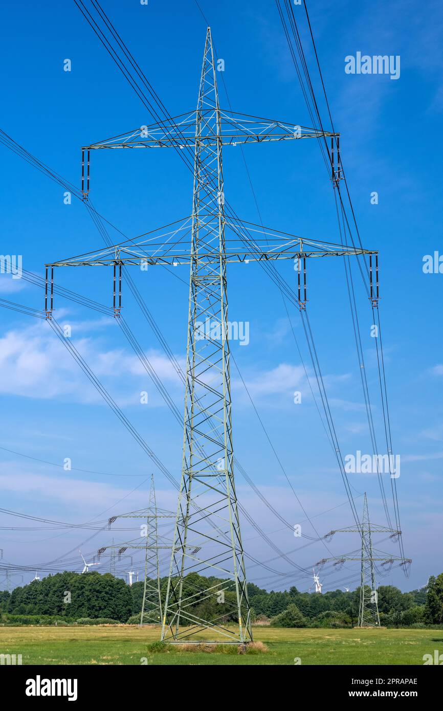 An electricity pylon in front of a blue sky seen in Germany Stock Photo ...