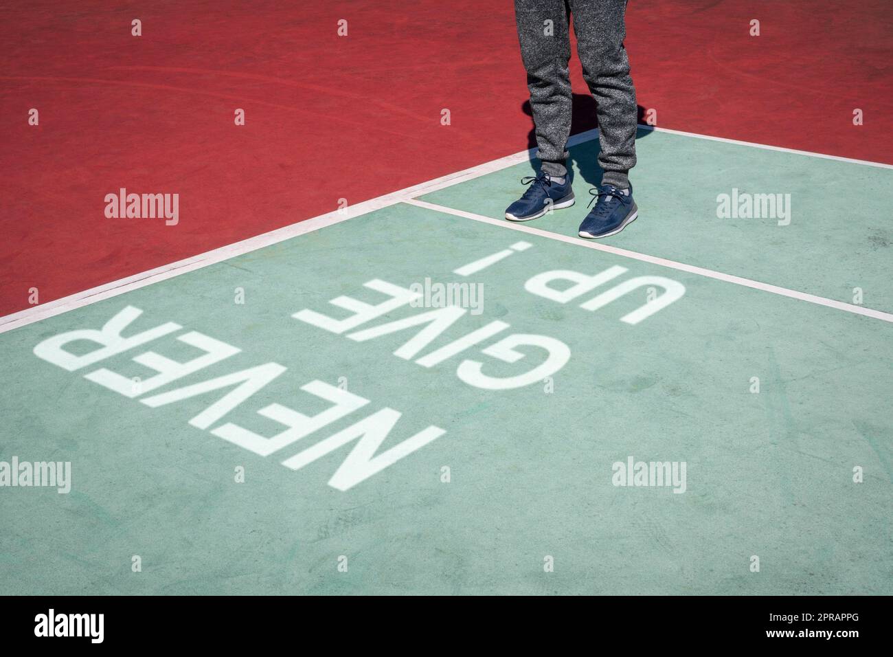 Man standing next to line with words NEVER GIVE UP Stock Photo - Alamy
