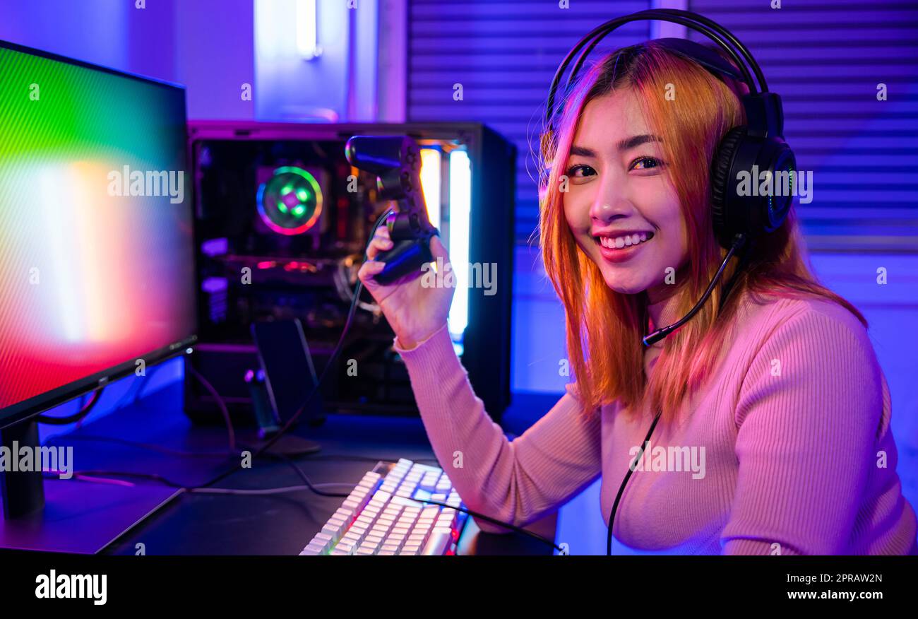 Smiling gamer using joystick controller for tournament plays online ...