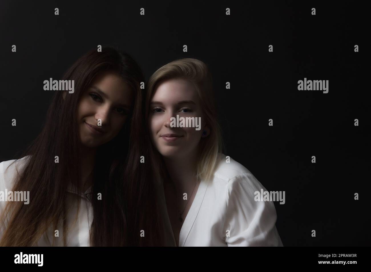 Low key portrait of two young women Stock Photo - Alamy