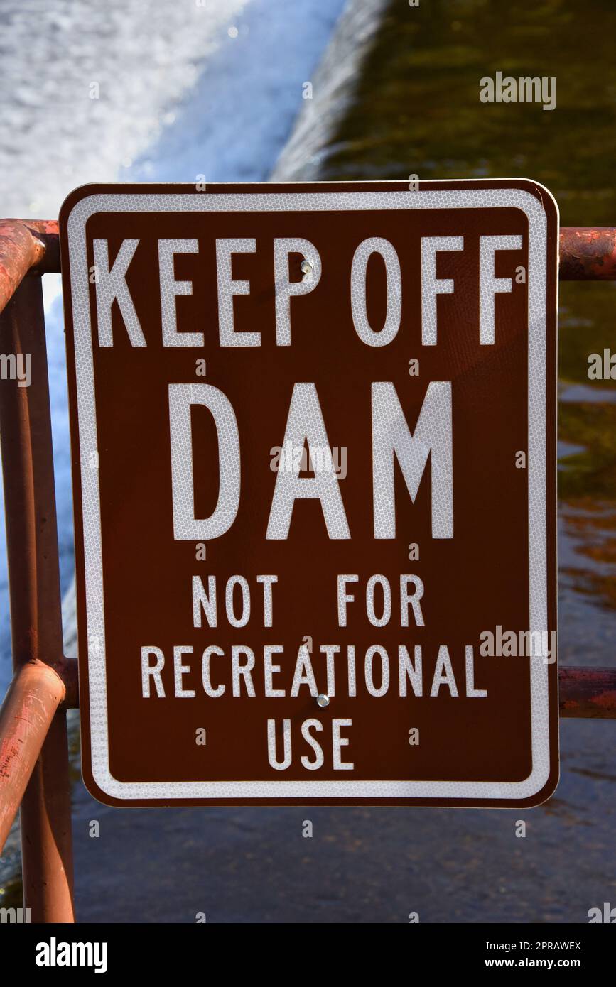 Warning sign is posted besides Weir Dam and the Doe River in ...