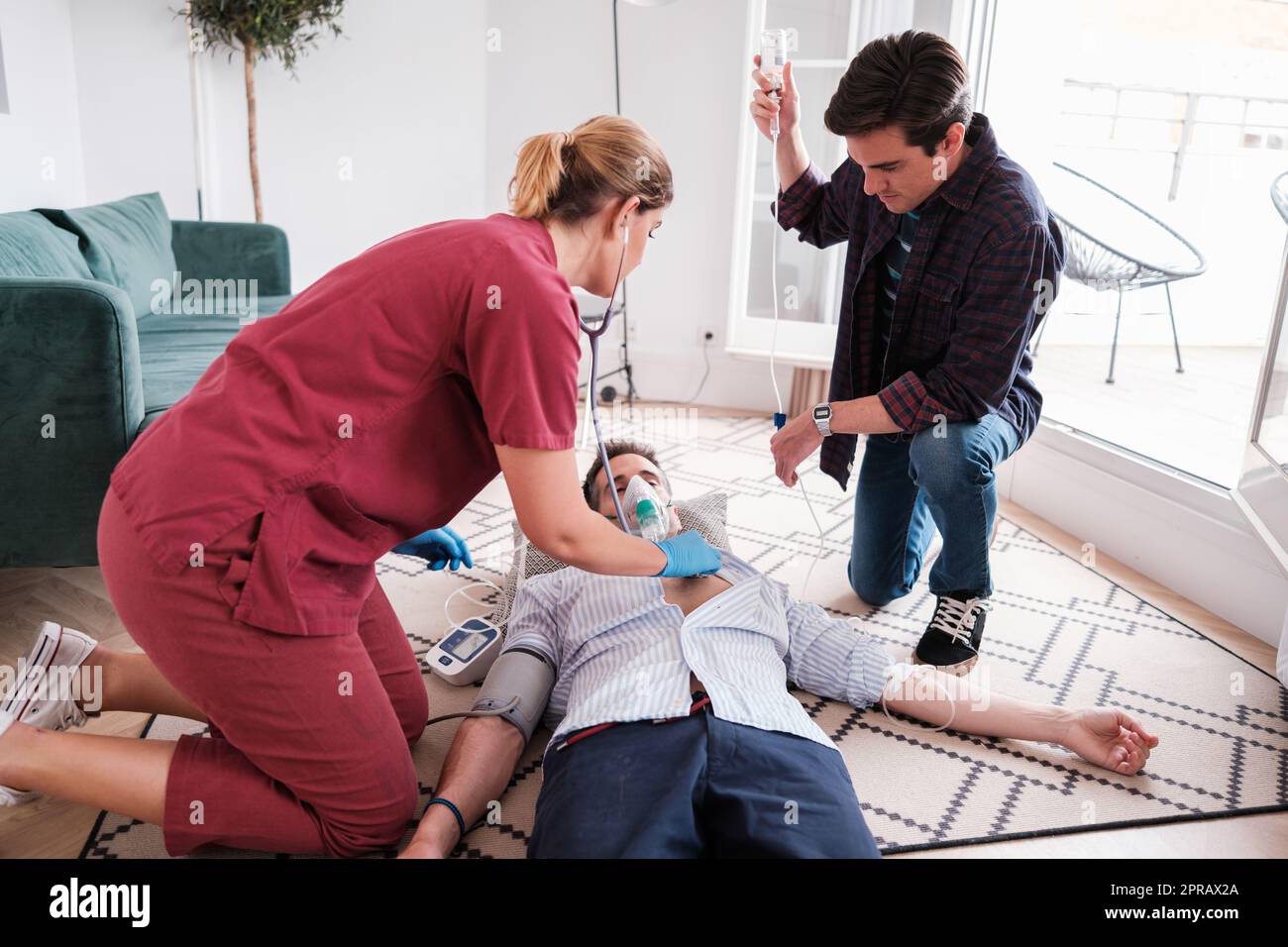 Emergency doctor attending an emergency at a home and receives help ...