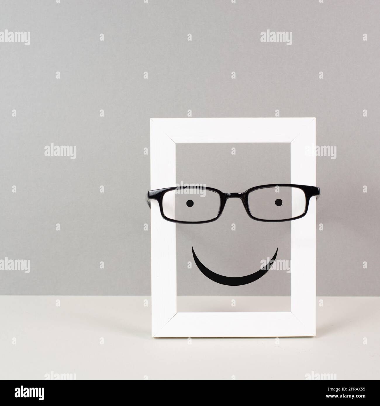 Frame with a happy face with eyeglasses, mental health concept ...