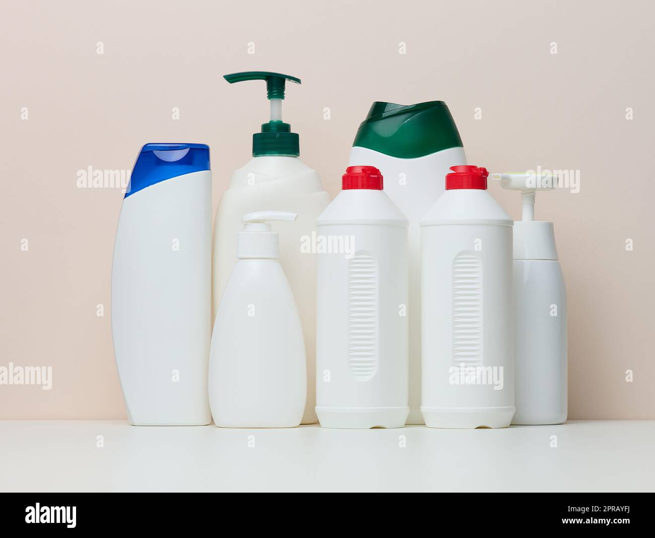 Various white plastic bottles for cosmetics, liquid soap, gel and ...