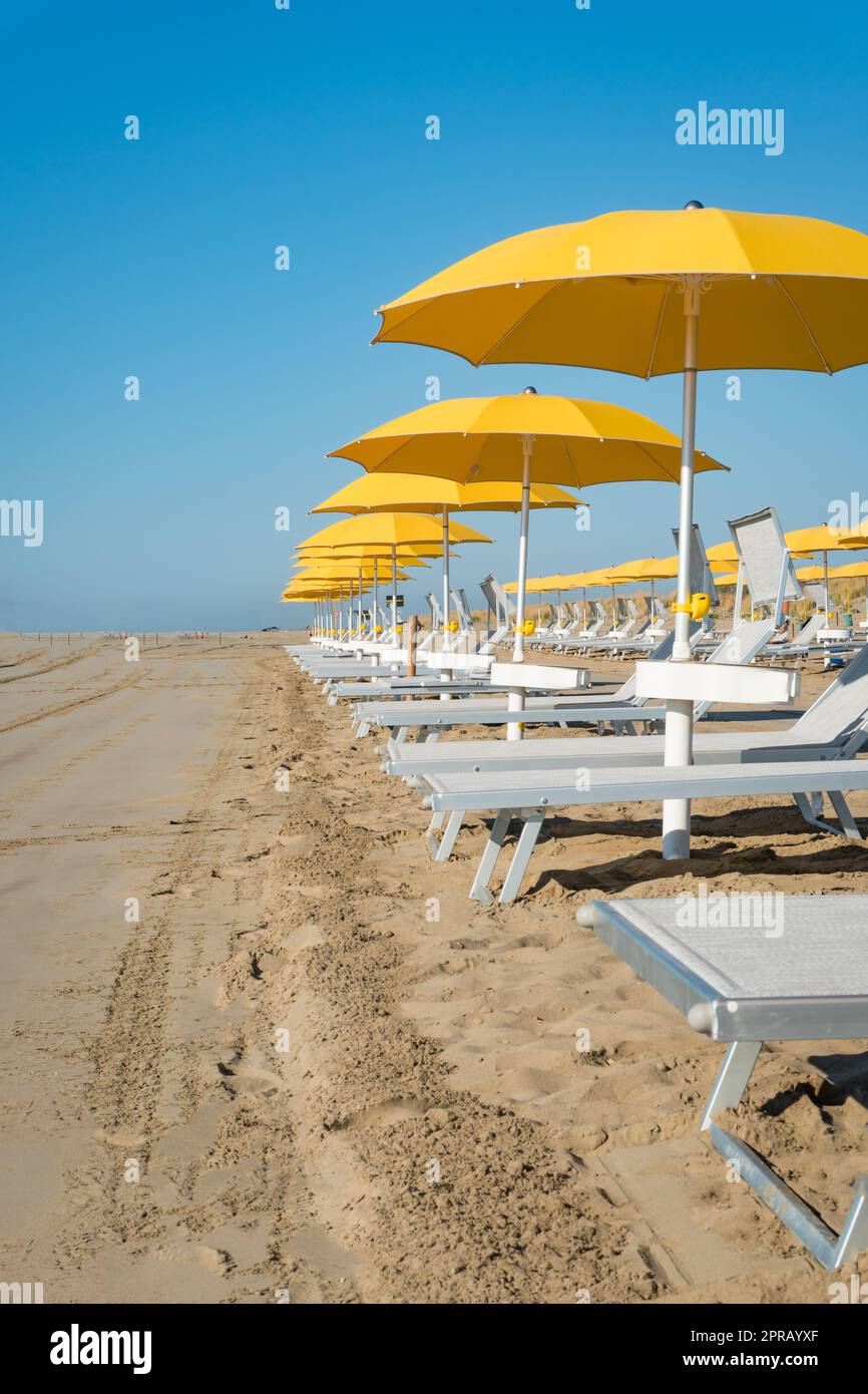 Yellow Parasol sun umbrella and sunbed at the empty beach Stock Photo ...