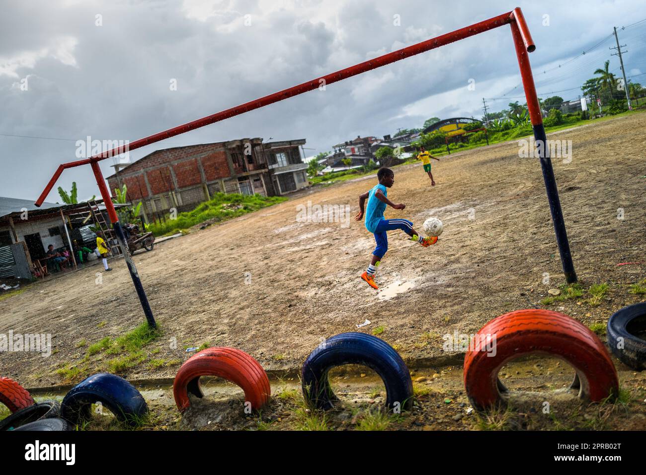 Afro-Colombian boys drill shooting during a football training session ...