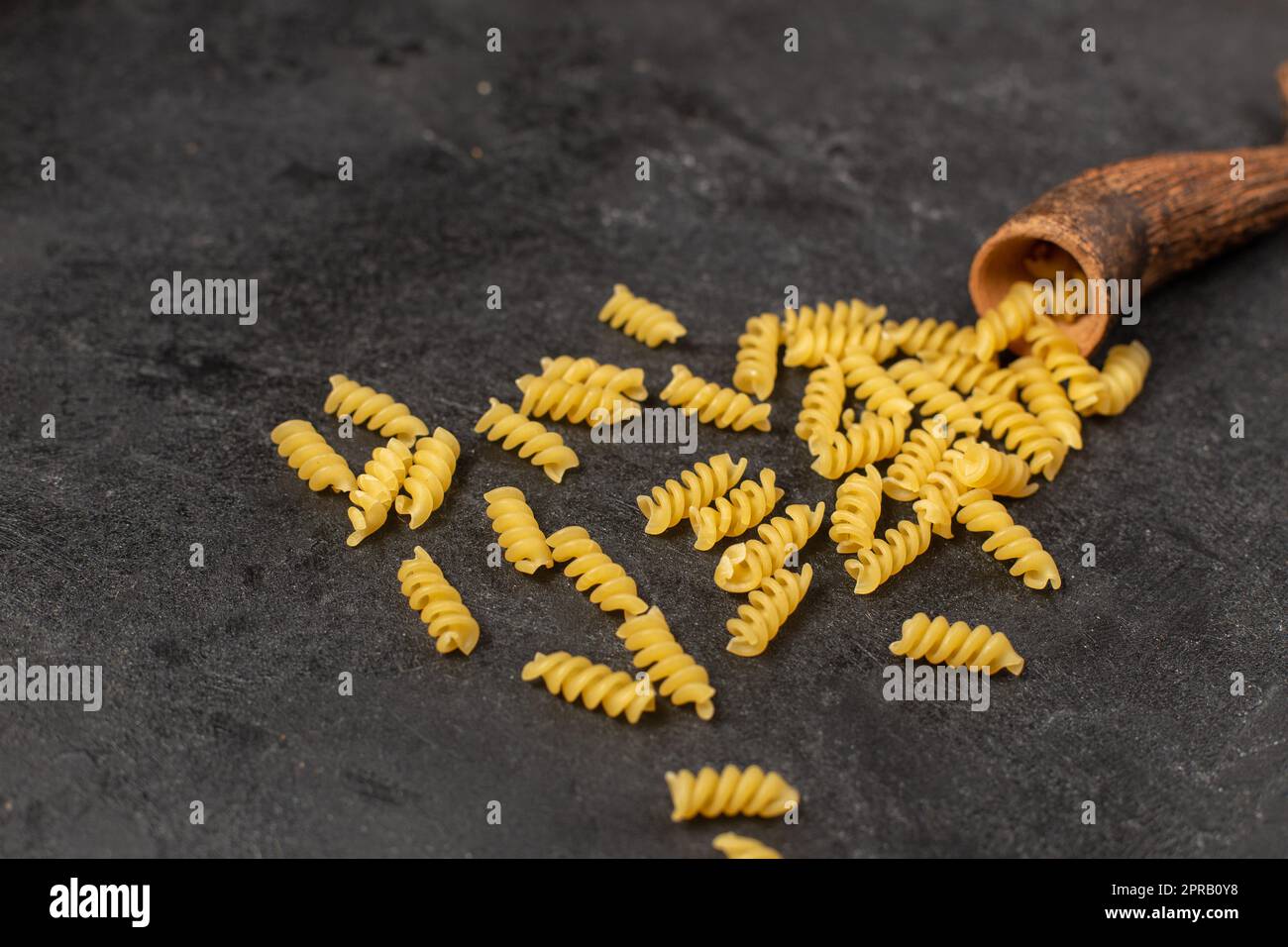 front view italian pasta little formed and raw on the dark background ...