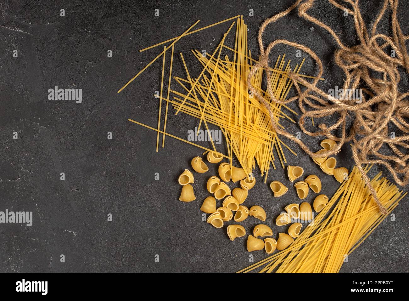 top view raw italian pasta long and little formed along with ropes on ...