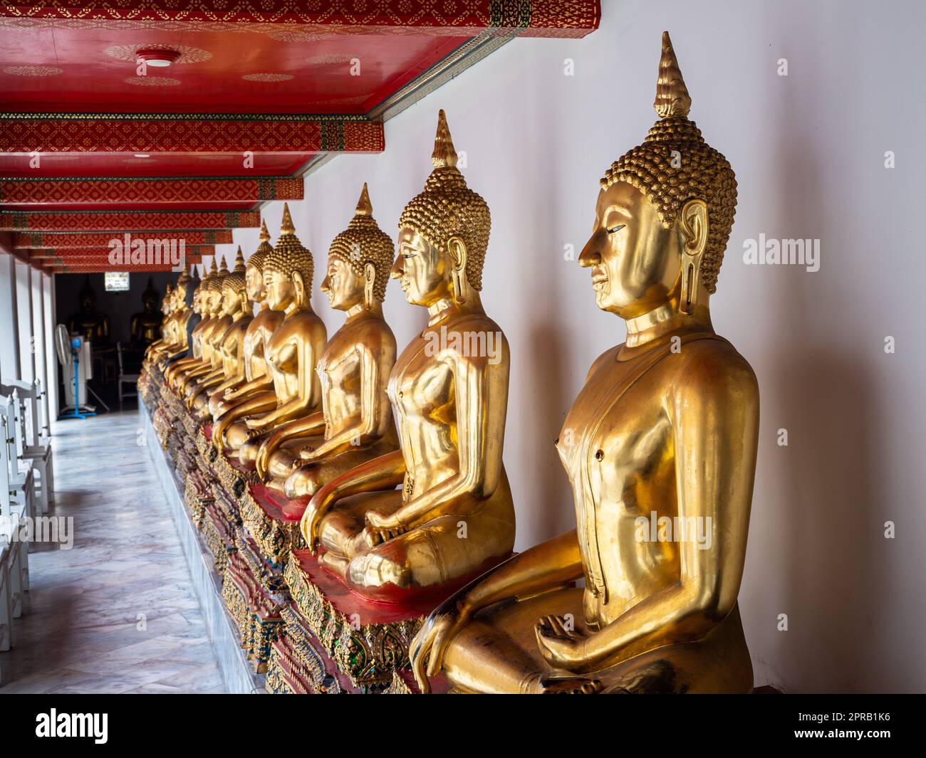 A stunning sight of a long line of Golden Buddha statues adorning the ...