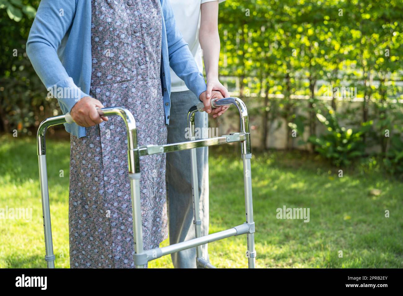 Caregiver help and care Asian senior or elderly old lady woman use ...