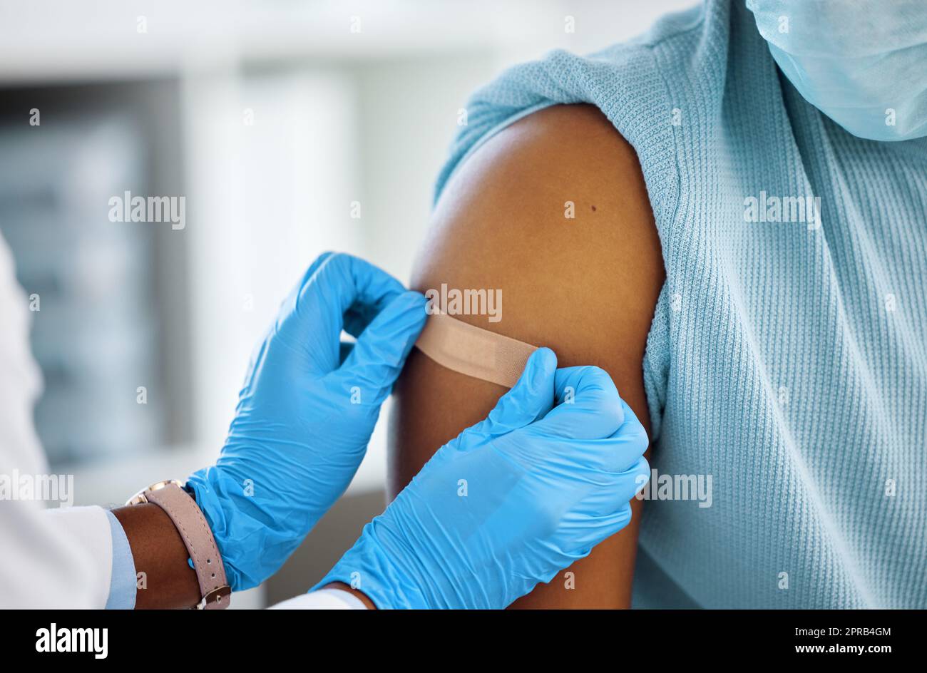 Just leave this on for an hour. a doctor applying a plaster to her ...
