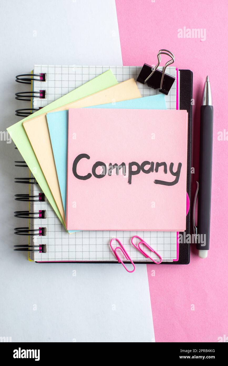 top view company written note with stickers on white-pink background ...