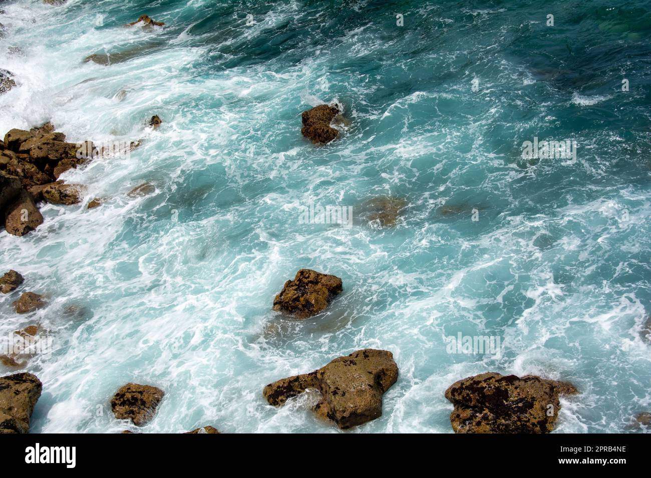 Rock in the surf Stock Photo - Alamy