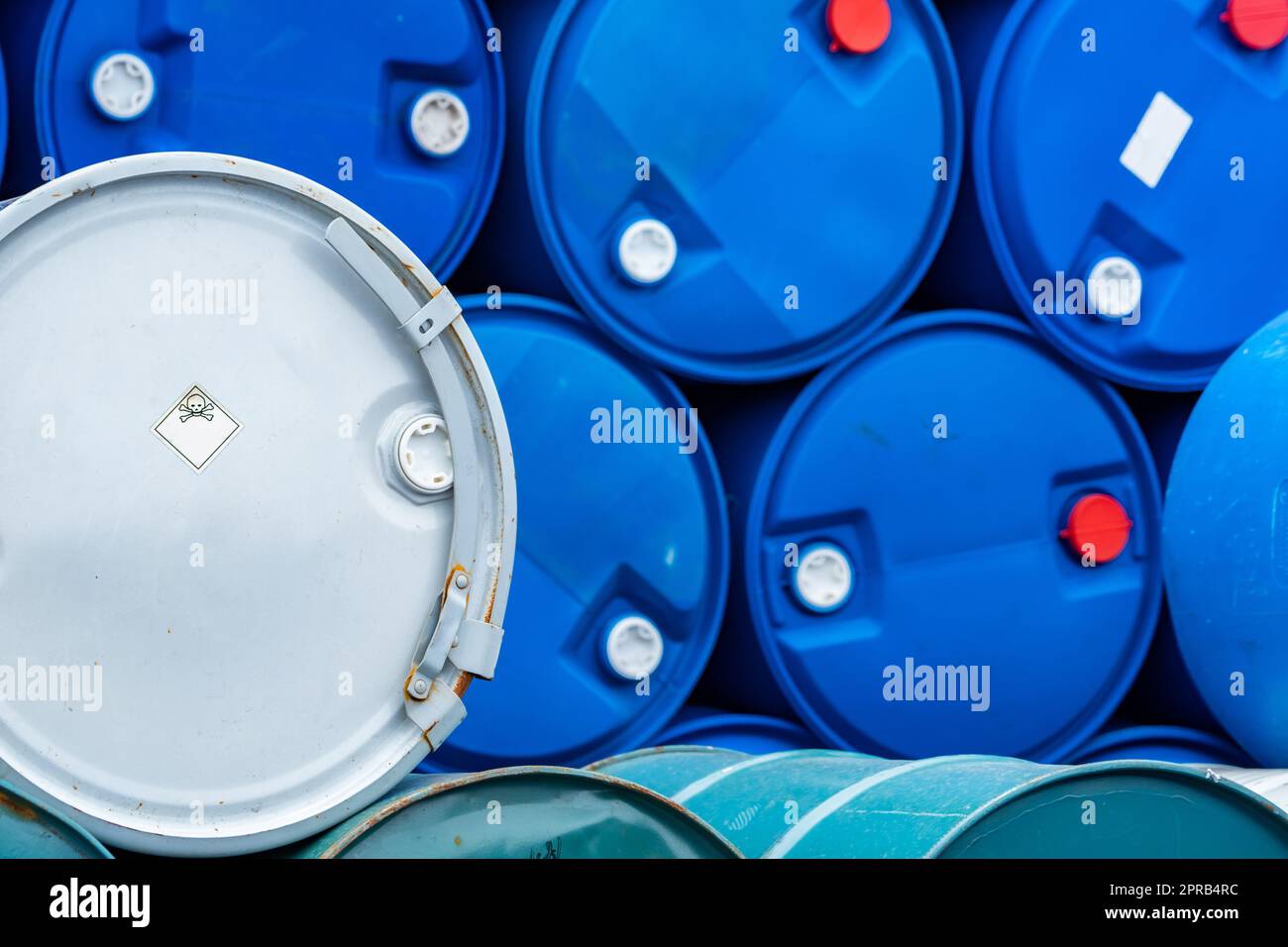 Old chemical barrels. Blue and green oil drum. Steel and plastic oil ...