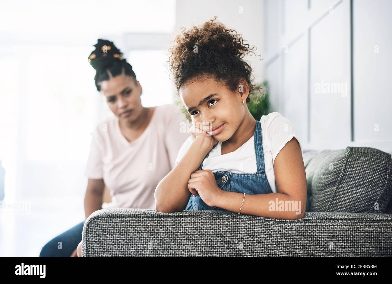 Can I go play now. a young mother reprimanding a child at home Stock ...