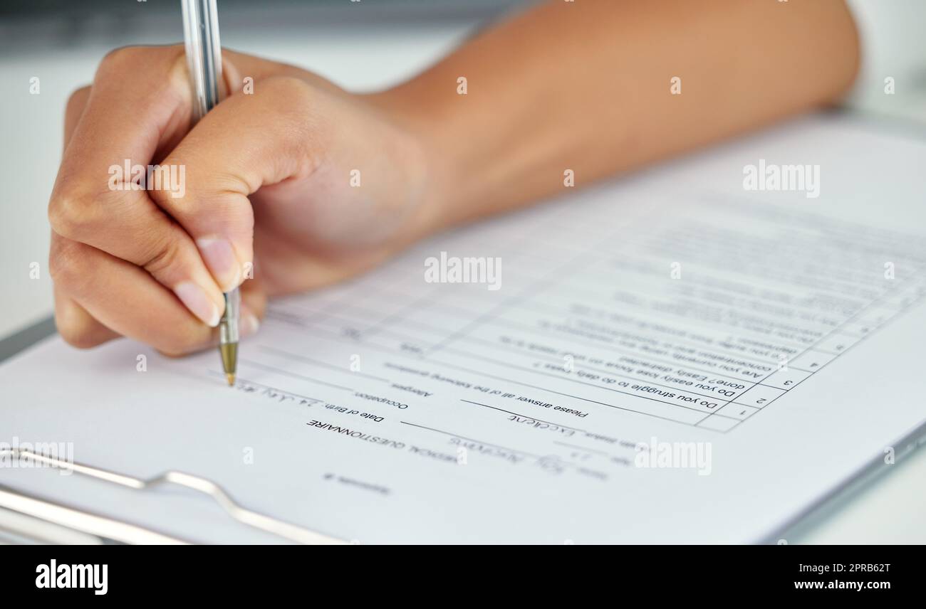 Taking a quick survey. an unrecognizable businesswoman filling out a ...
