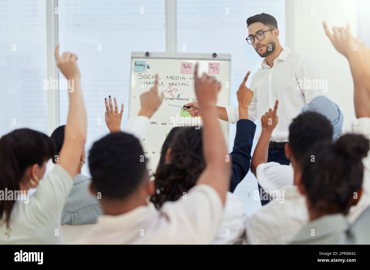 Theyre full of questions today. a handsome young businessman giving a ...