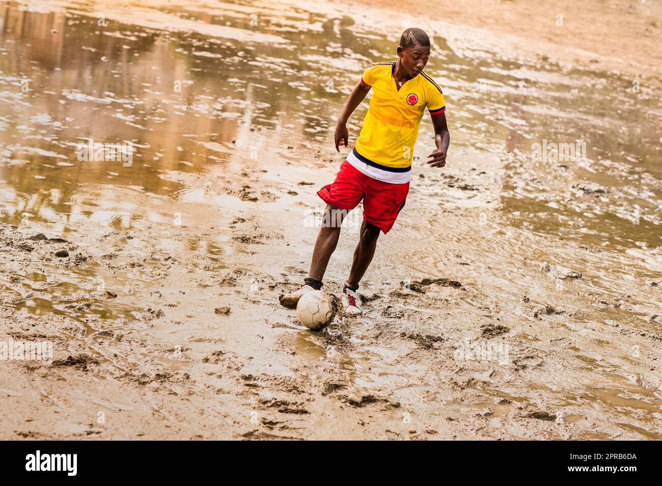 A young Afro-Colombian football player plays a match during a training ...