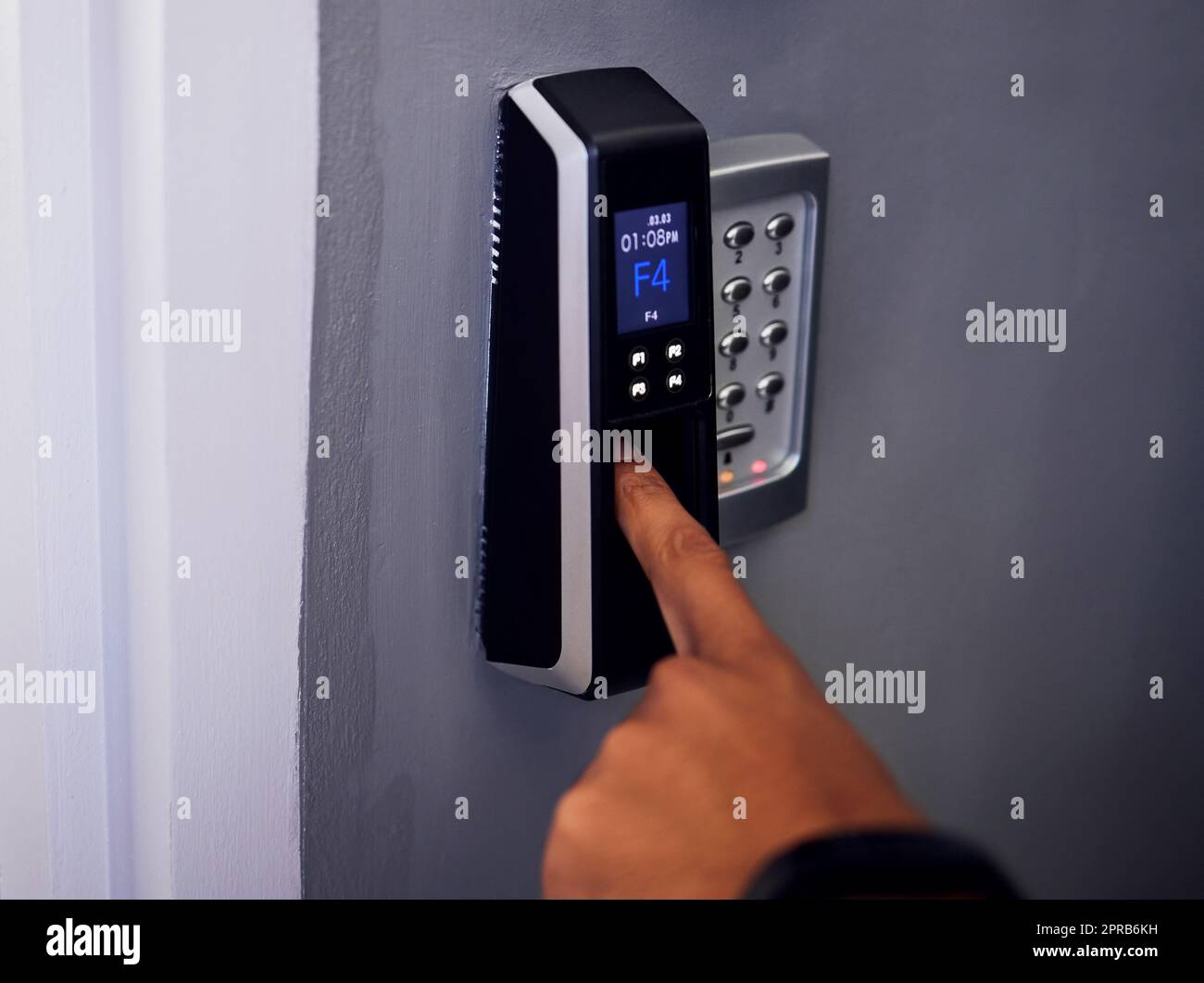 Security is important. an unrecognizable man using his finger to gain ...