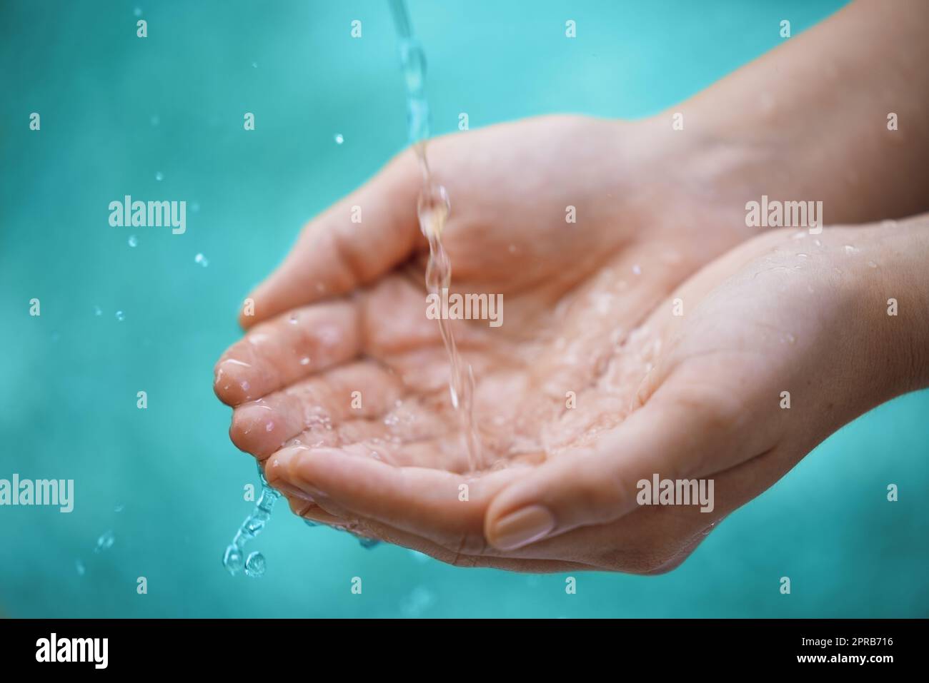 Stay water wise. water flowing onto the hands of an unrecognizable ...