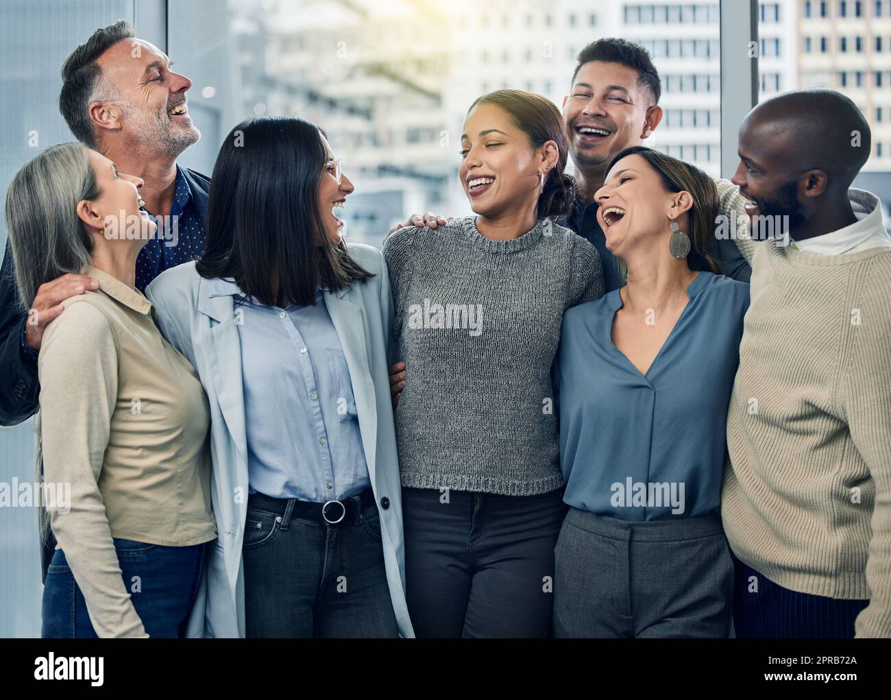 We love working together. a team of colleagues together in their office ...