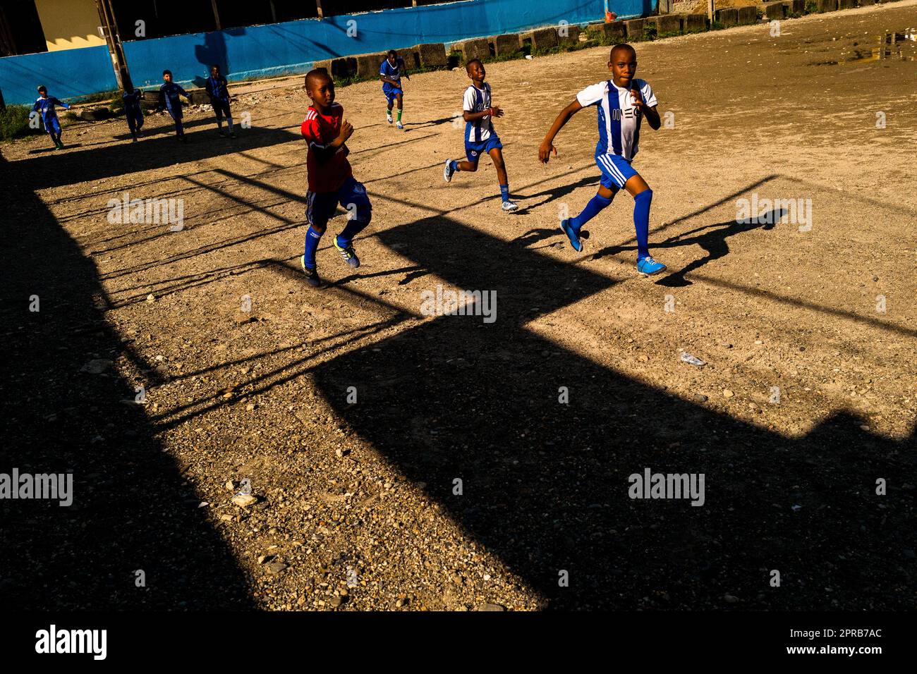 Afro-Colombian boys practice short sprints during a football training ...