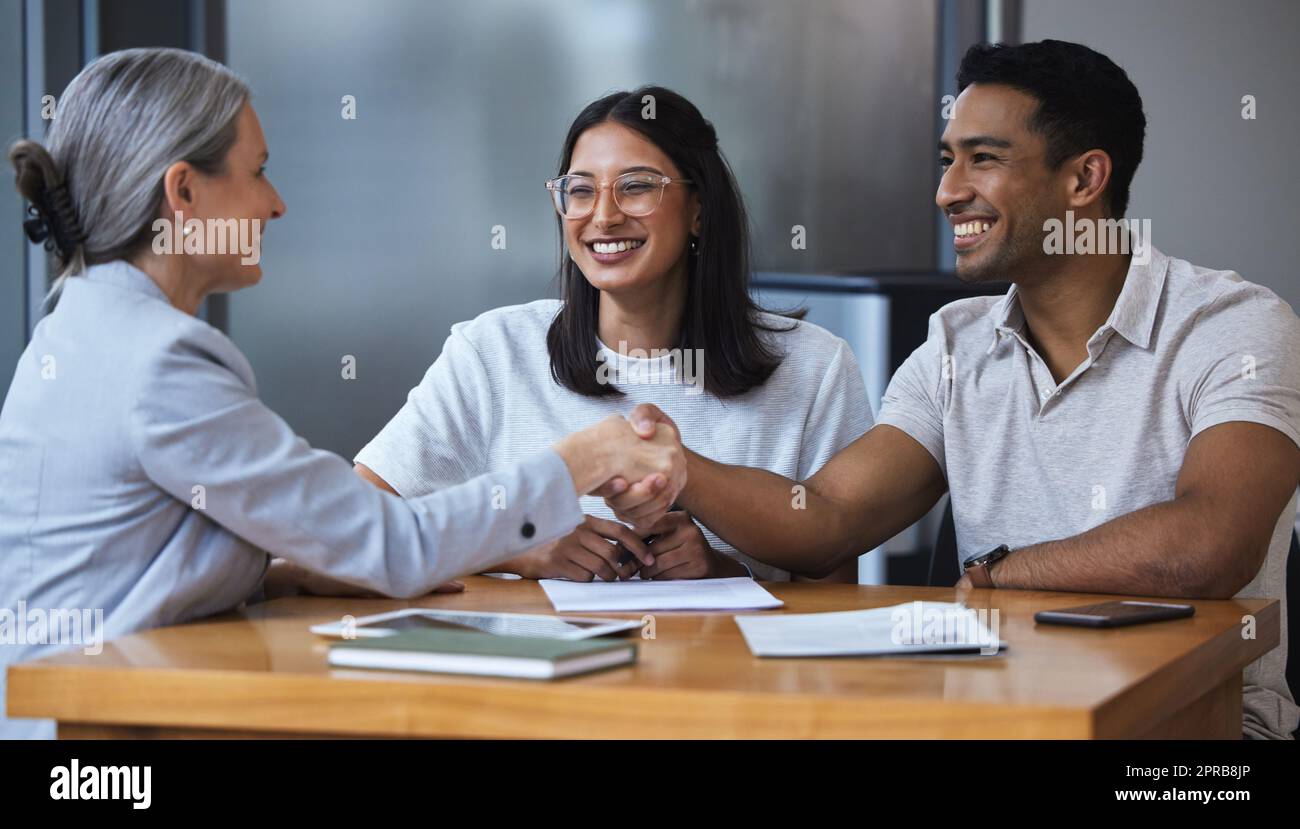 One destination, two cars. a young couple meeting with a consultant to ...