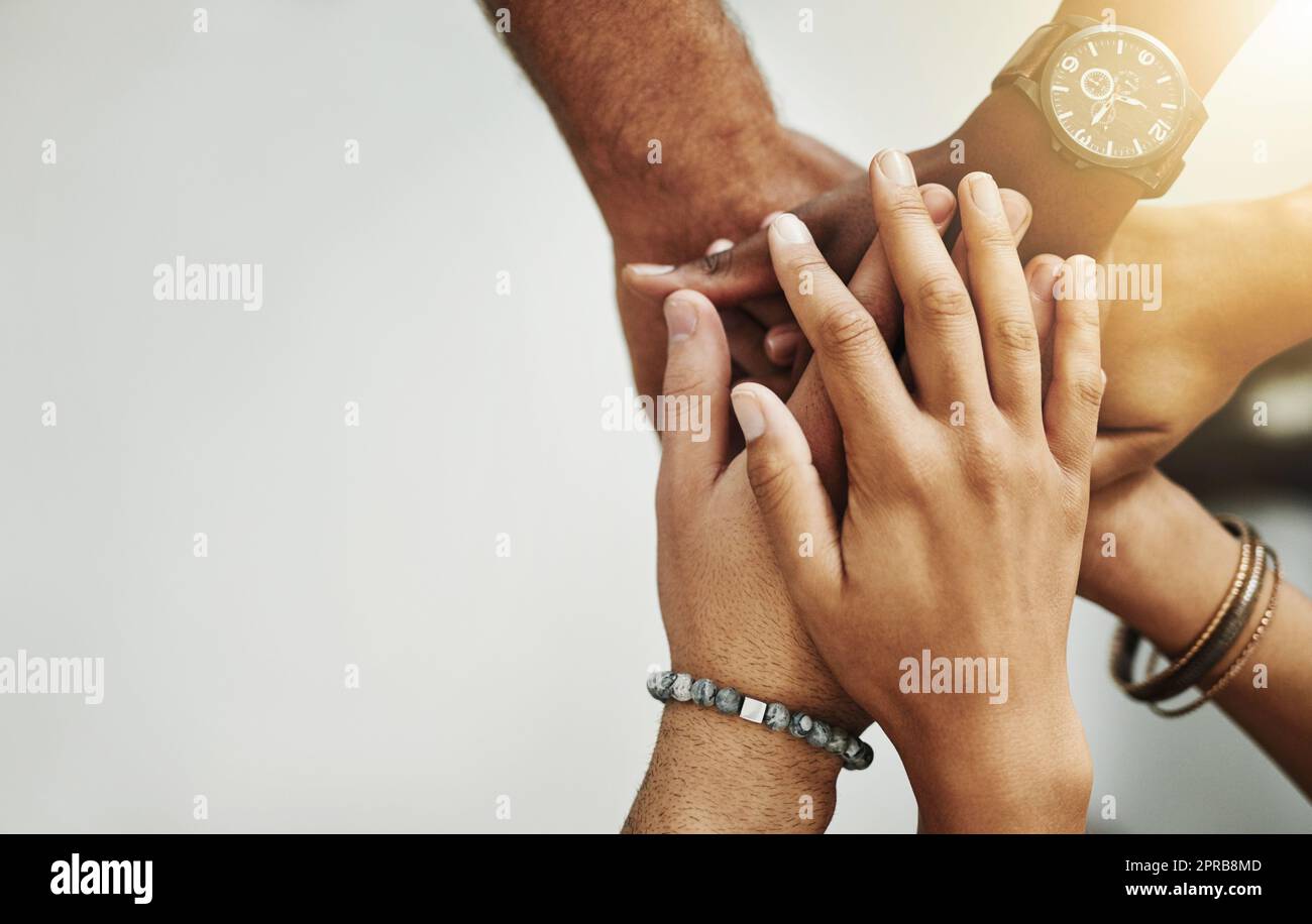 Group of business people holding hands together in unity, support and ... Group of business people holding hands together in unity, support and ...