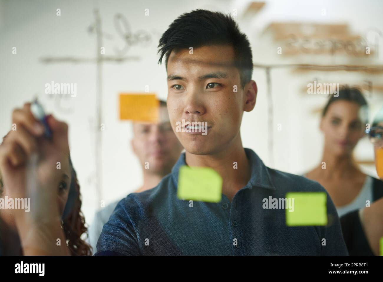 Closeup of marketing professional brainstorming ideas with colleagues ...