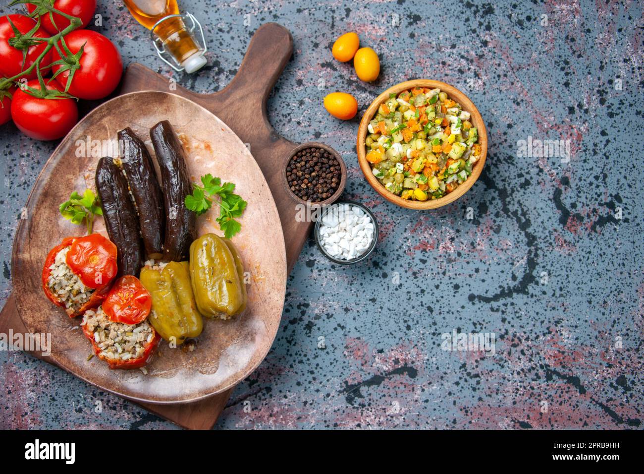 top view delicious vegetable dolma with salad and tomatoes on blue ...