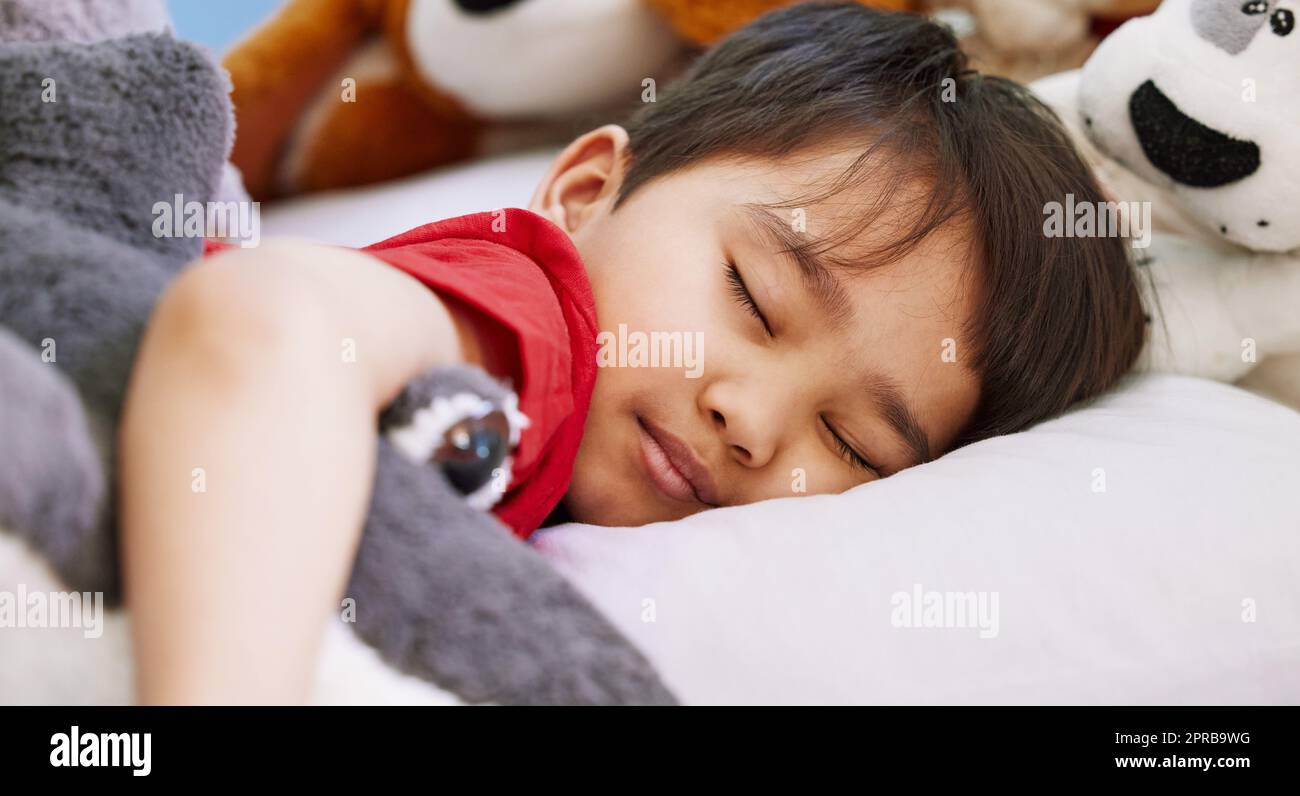 Recharging his energy with an afternoon nap. an adorable little boy ...