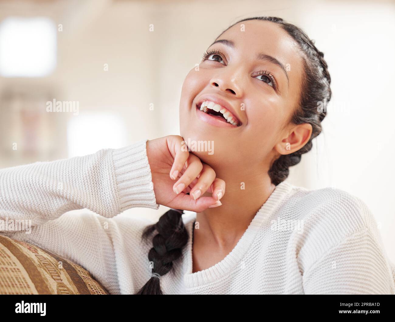 A relaxed mind is an inspired mind. a young woman relaxing on the sofa ...