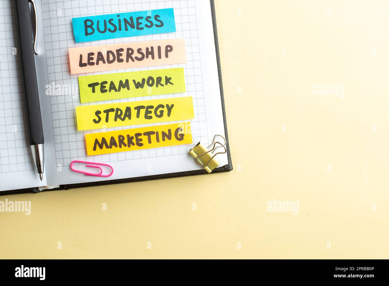 top view different business terms on little stickers in notepad light ...